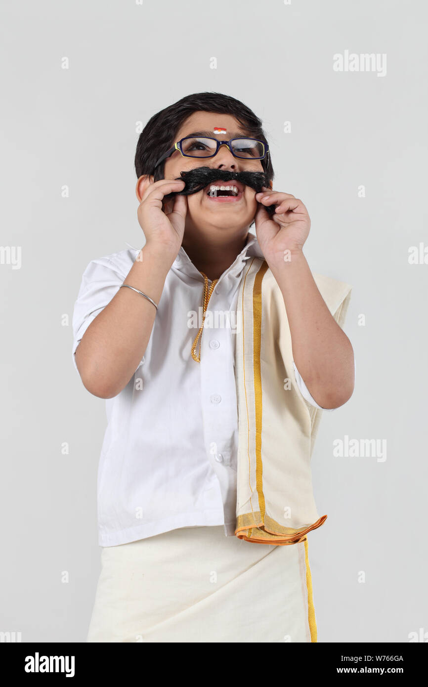 Boy pretending to be a south Indian showing mustache Stock Photo - Alamy