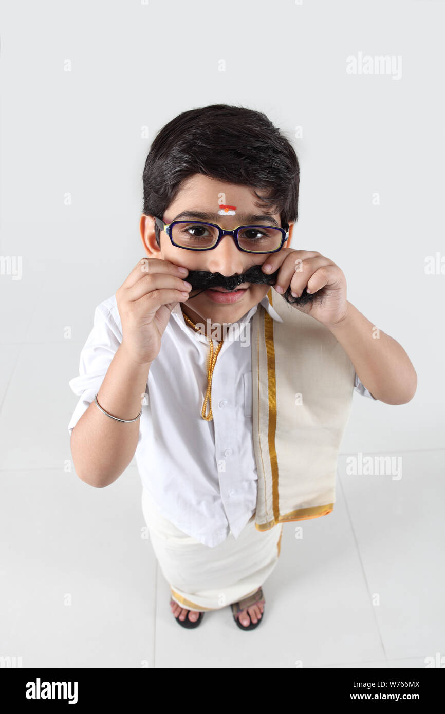 Boy pretending to be a south Indian showing mustache Stock Photo - Alamy