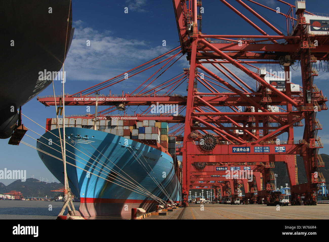 A Emma M?rsk container ship berths with containers to be shipped abroad on a quay at the Ningbo ...