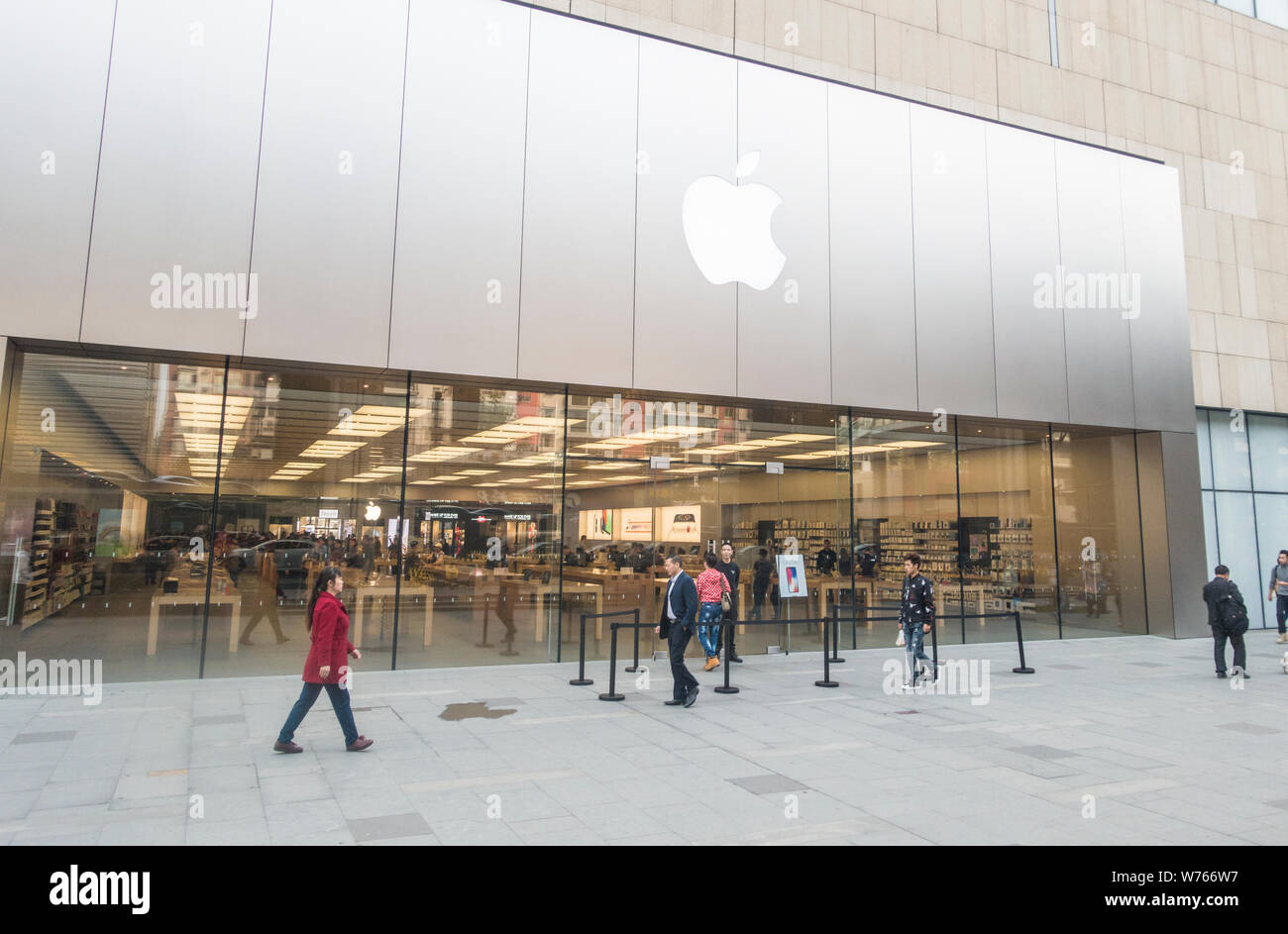--FILE--Pedestrians walk past an Apple store in Chengdu city, southwest ...