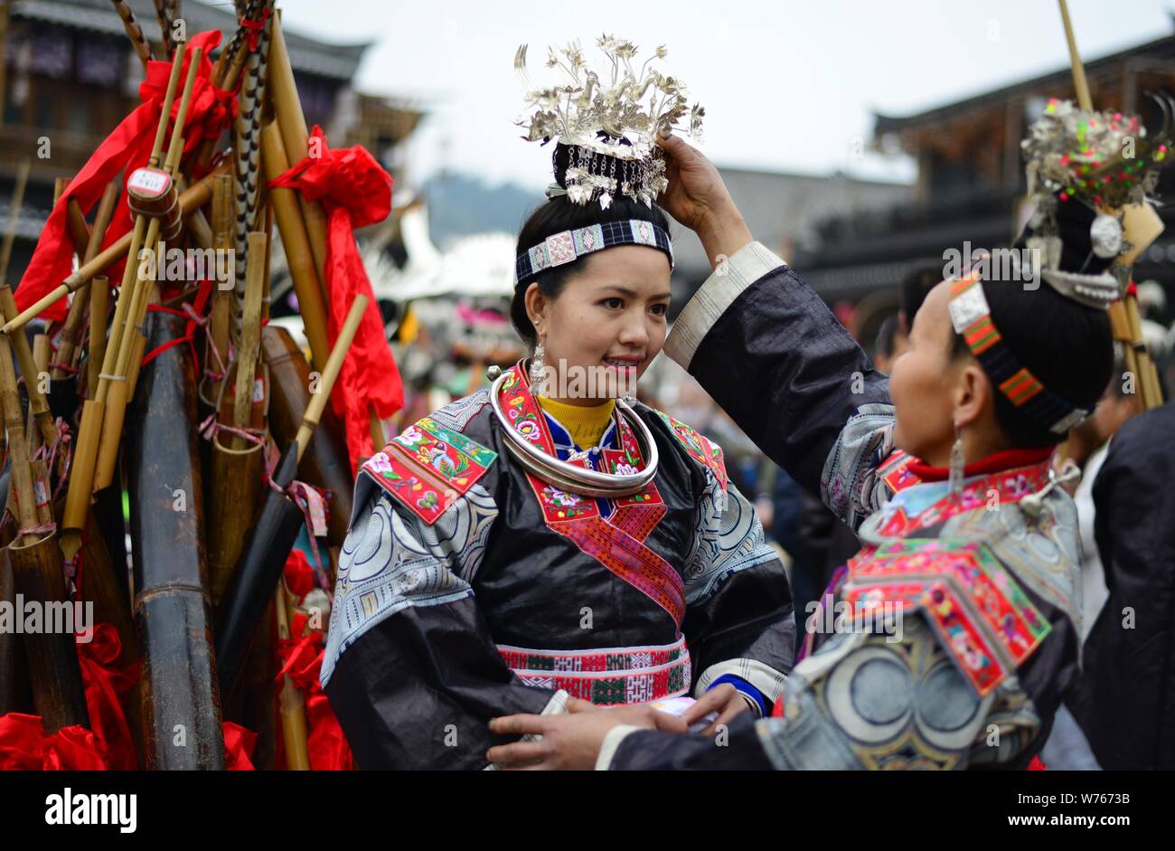 Chinese girls of Miao ethnic minority dressed in traditional silver ...