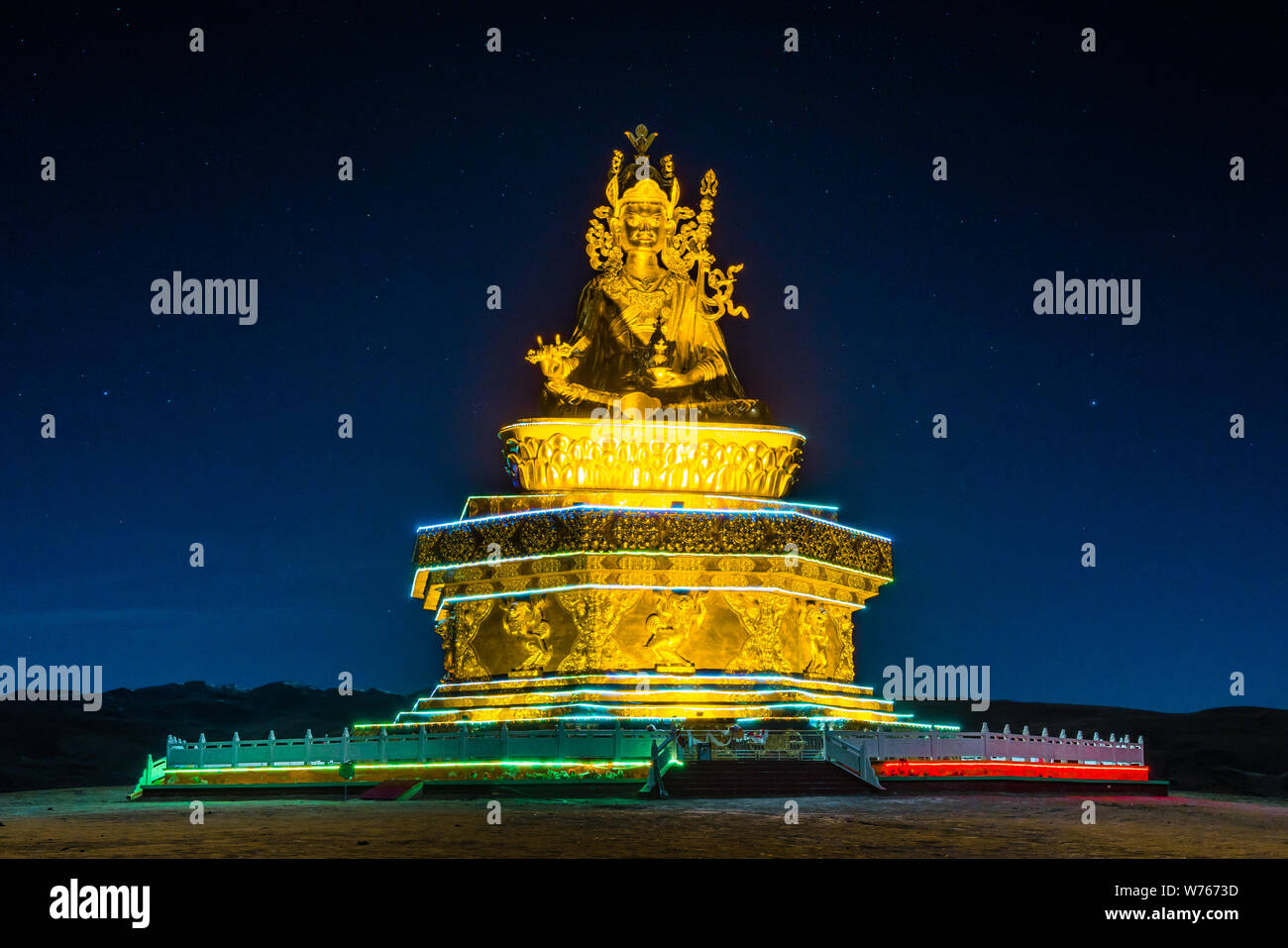 A golden-hued tower is seen in this view of the Yarchen Gar Monastery ...