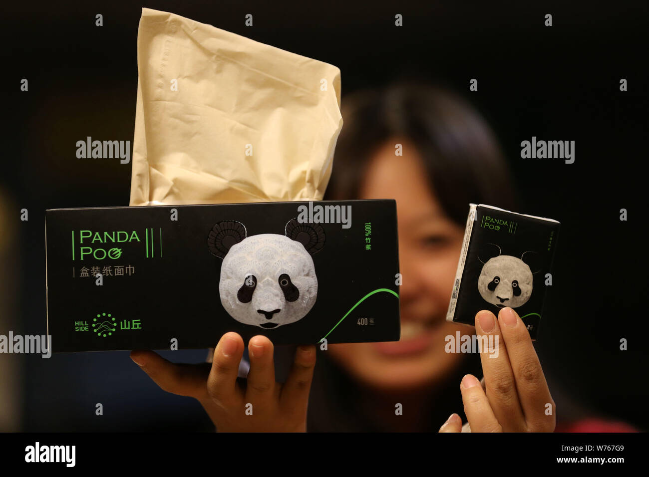 A Chinese worker shows tissue paper made from giant "panda poo" at a ...