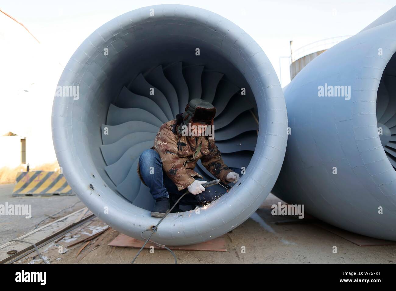 Chinese man Zhu Yue works on a turbine engine of his homemade Airbus ...
