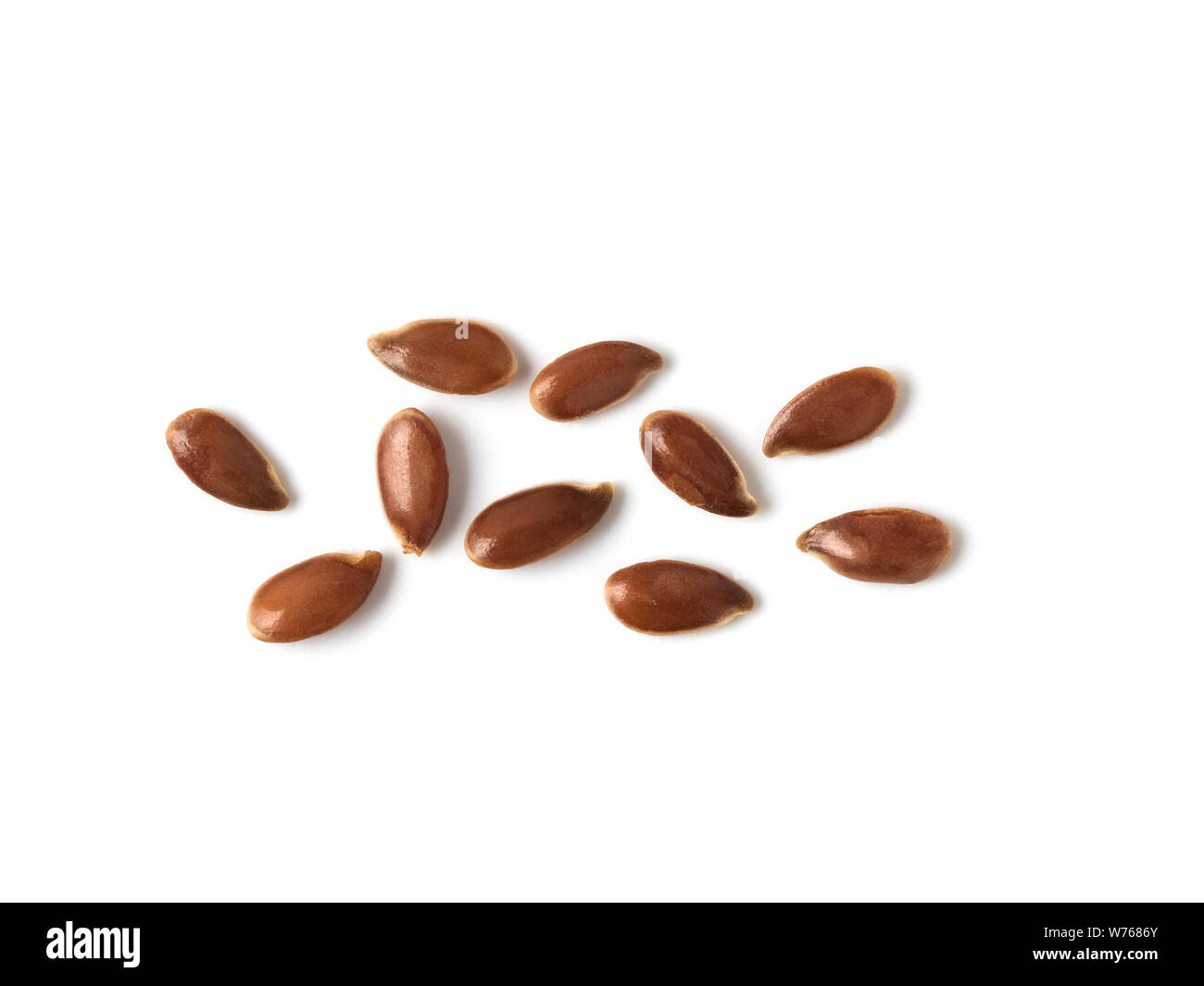 Extreme close up of flax seeds isolated on white background. Linseed pile closeup isolated on ...