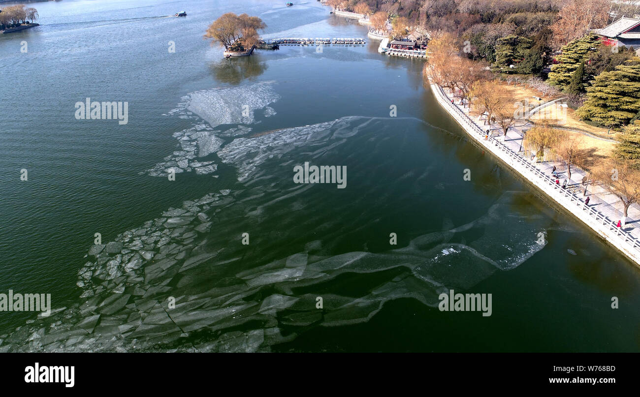 Aerial view of chunks of ice floating on Daming Lake, turning the scene ...