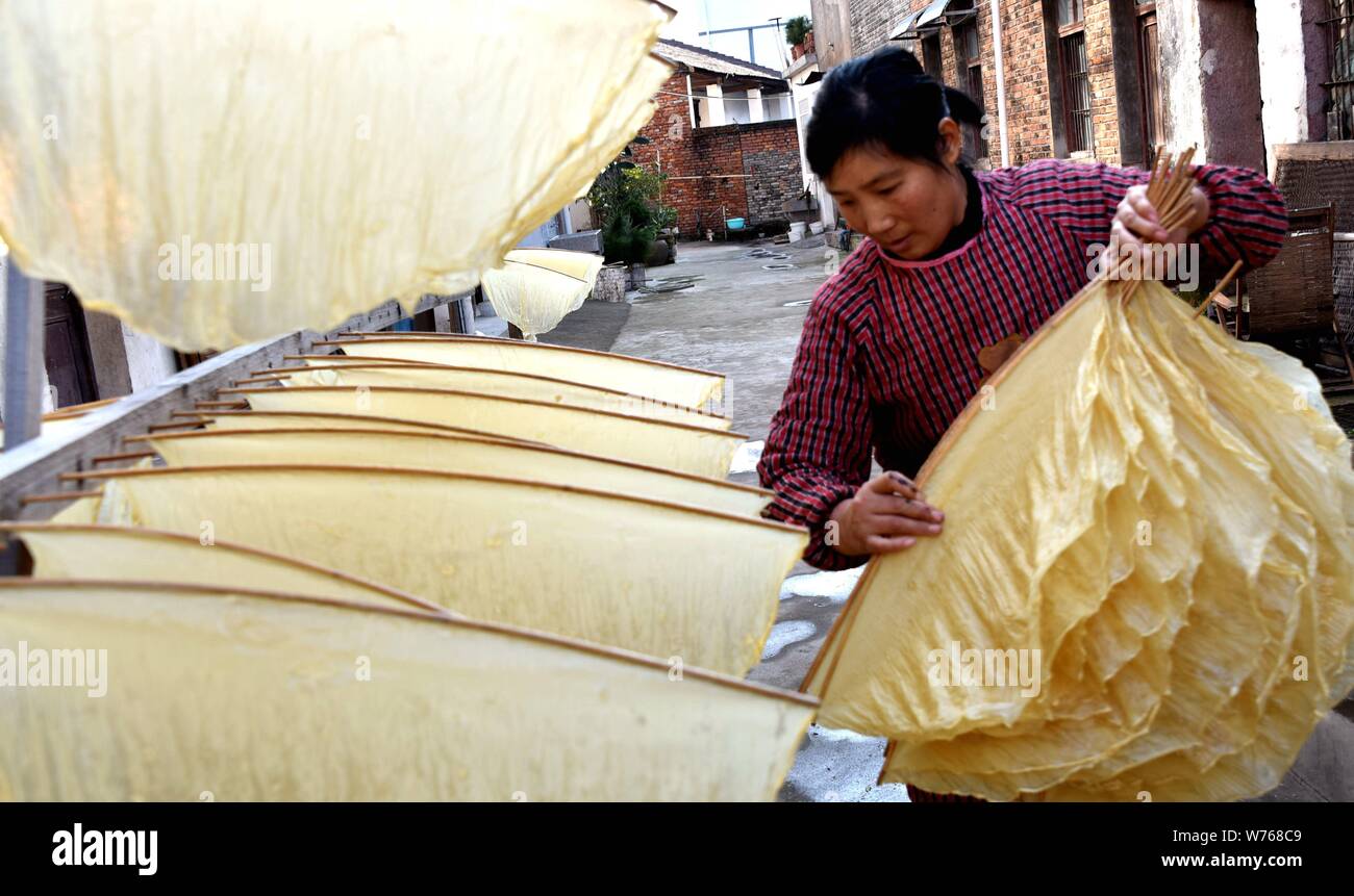 Chinese worker Fang Yanfen airs bean curd skin at Xiajie village of ...