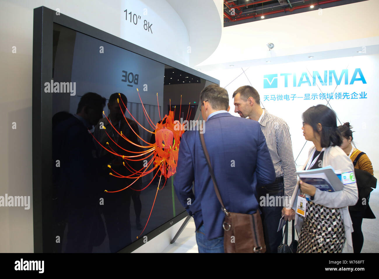 --FILE--Visitors look at 110-inch 8K ultra-high-definition (UHD) LCD ...