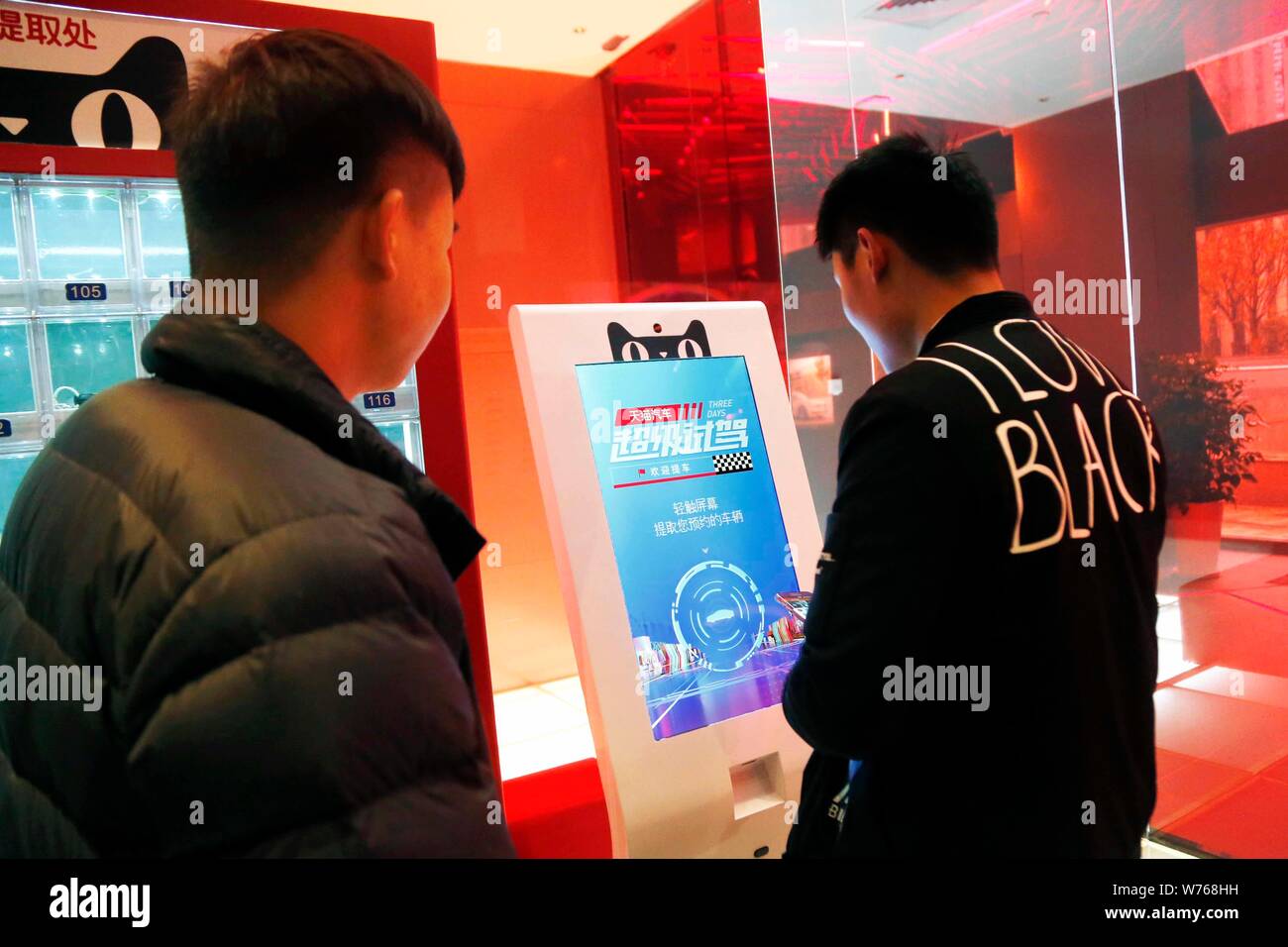 A customer operates on a touch screen to get the reserved car for a ...