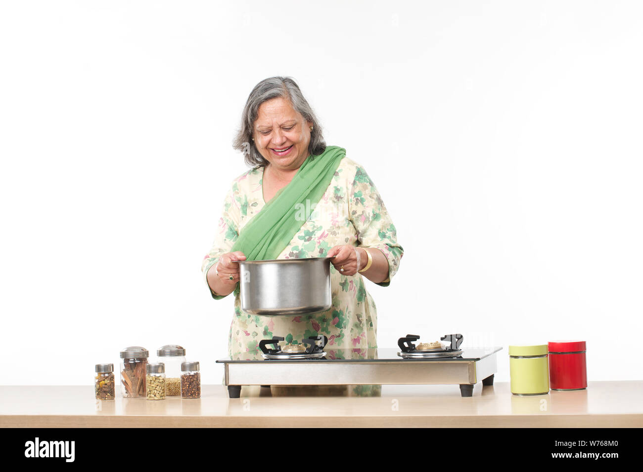 Old woman cooking food in a kitchen Stock Photo - Alamy