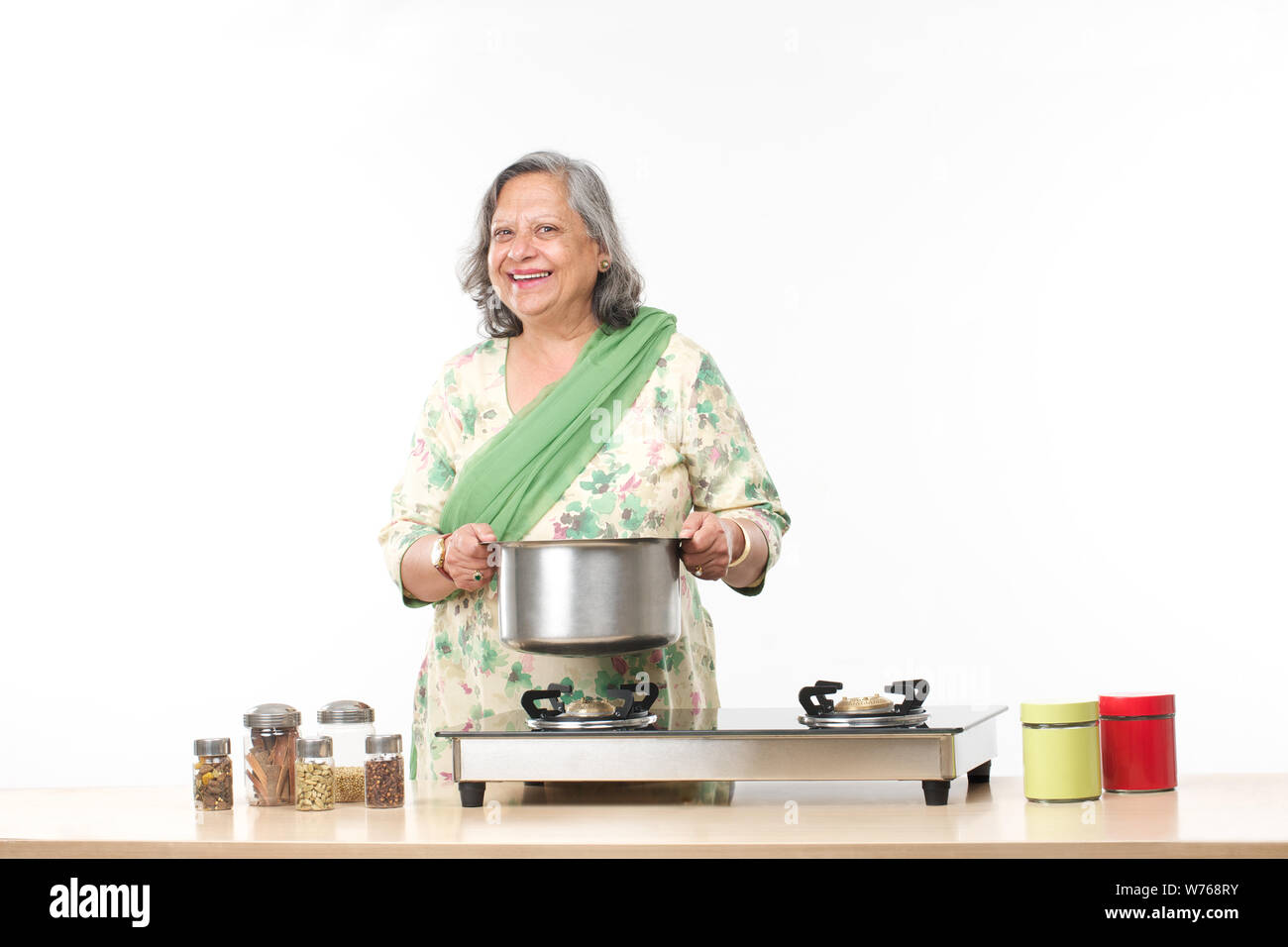 Indian old woman cooking food in kitchen Stock Photo - Alamy
