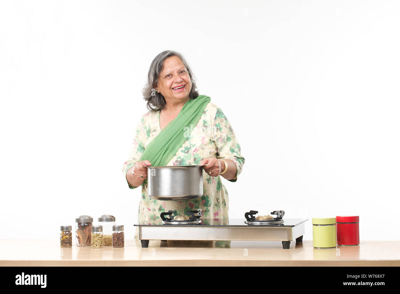 Old woman cooking food in kitchen Stock Photo - Alamy