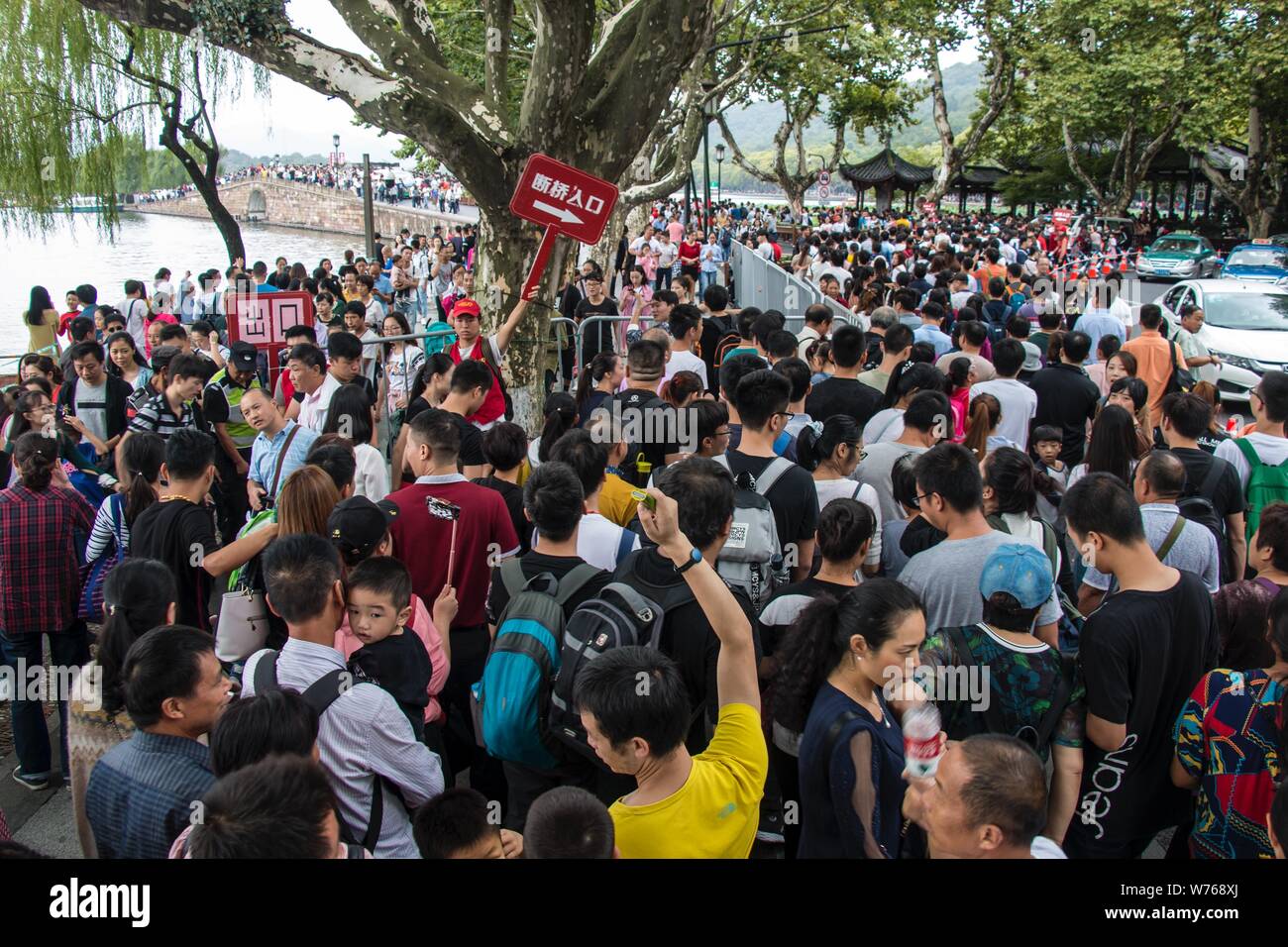--FILE--Tourists crowd the promenade along the West Lake during the ...