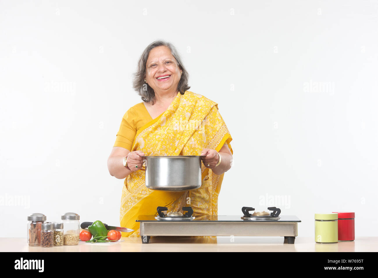 Old woman cooking food in kitchen Stock Photo - Alamy