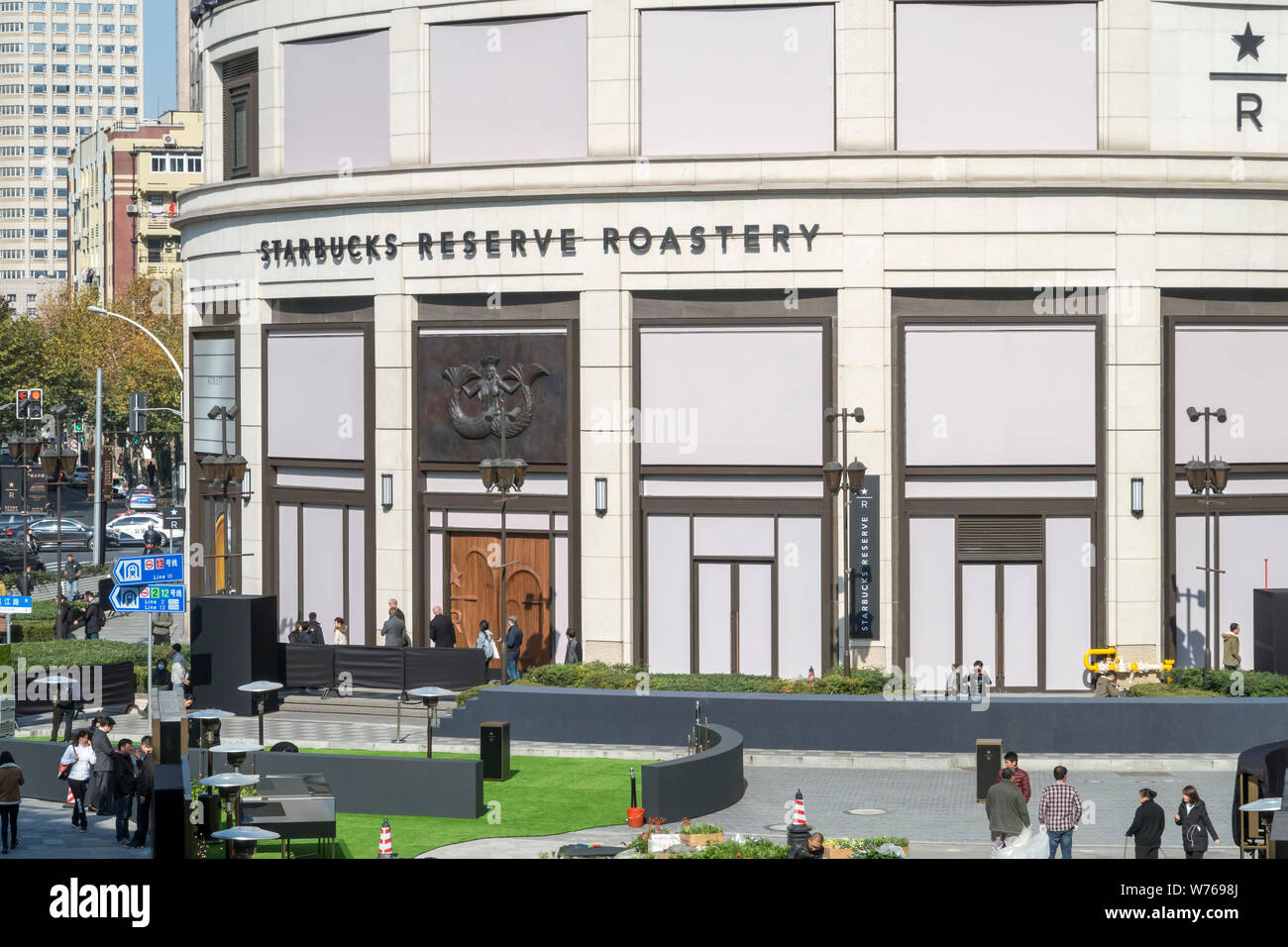 Chinese pedestrians walk past the world's largest Starbucks Reserve ...