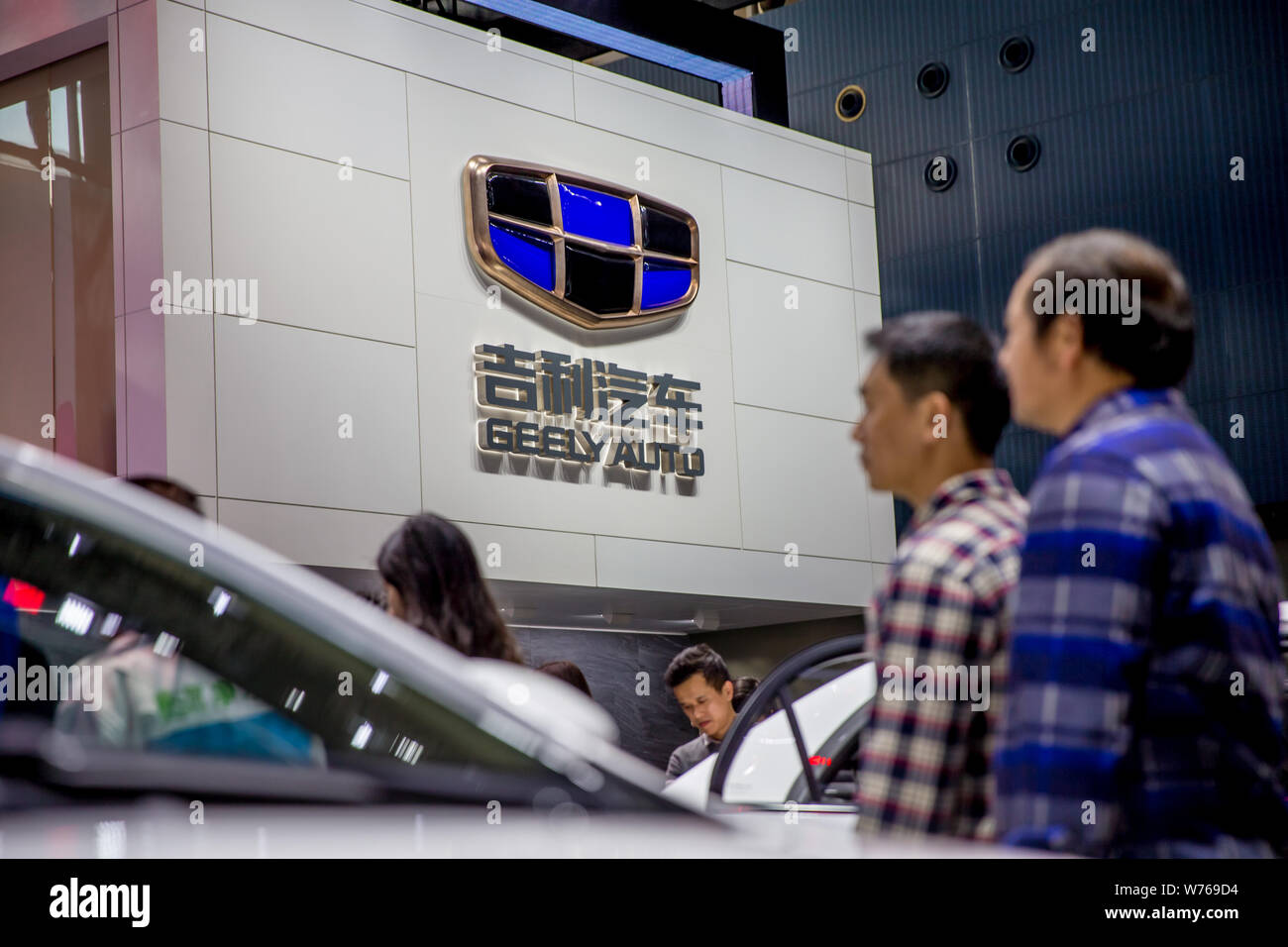 --FILE--People visit the stand of Geely during the 15th China ...