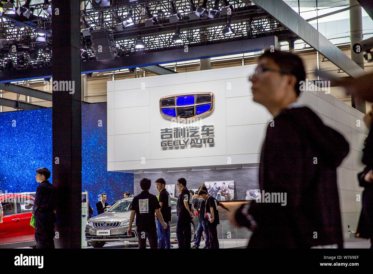 --FILE--People visit the stand of Geely during the 15th China ...