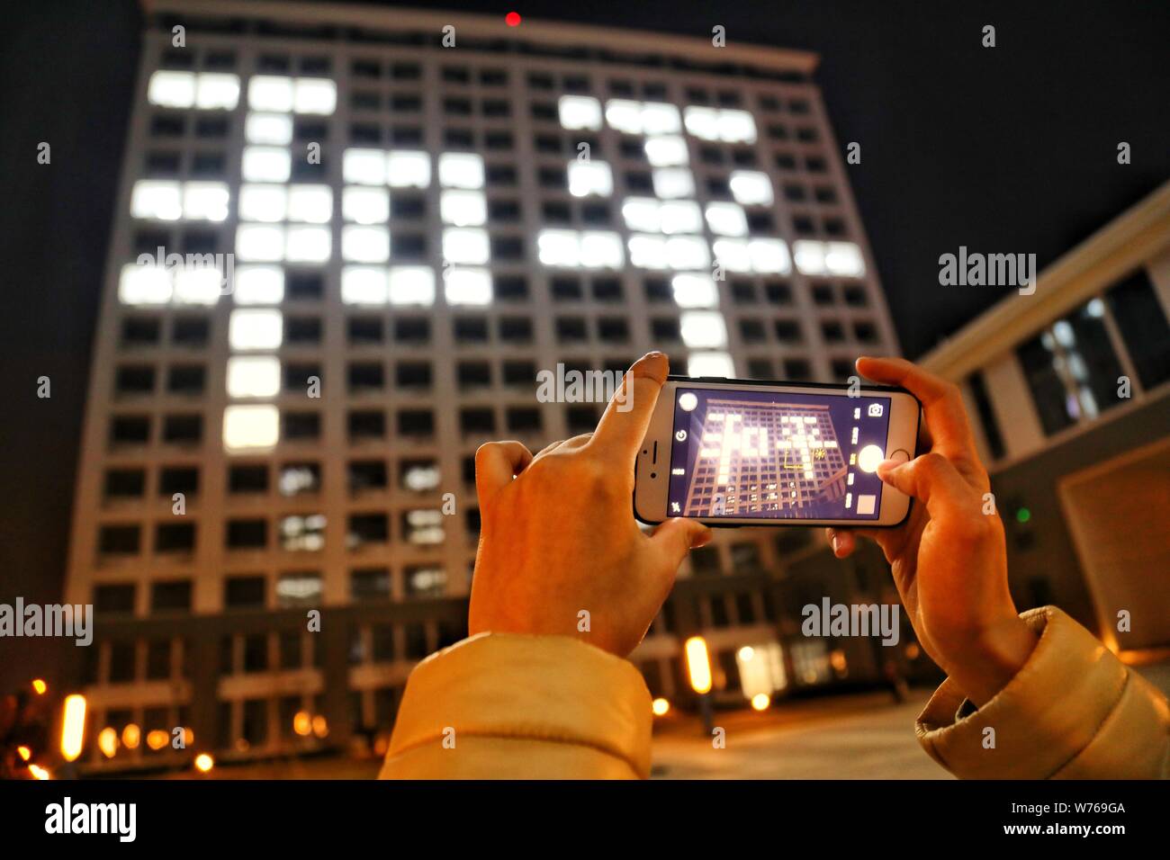 Dormitory buildings are lit up to form the Chinese characters "He Ping ...