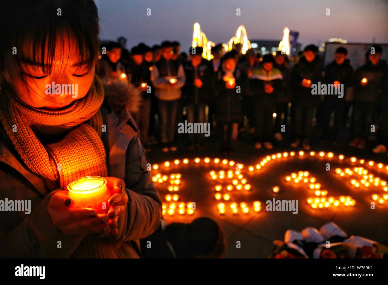 Chinese students hold candles during a candlelight vigil to mourn the ...
