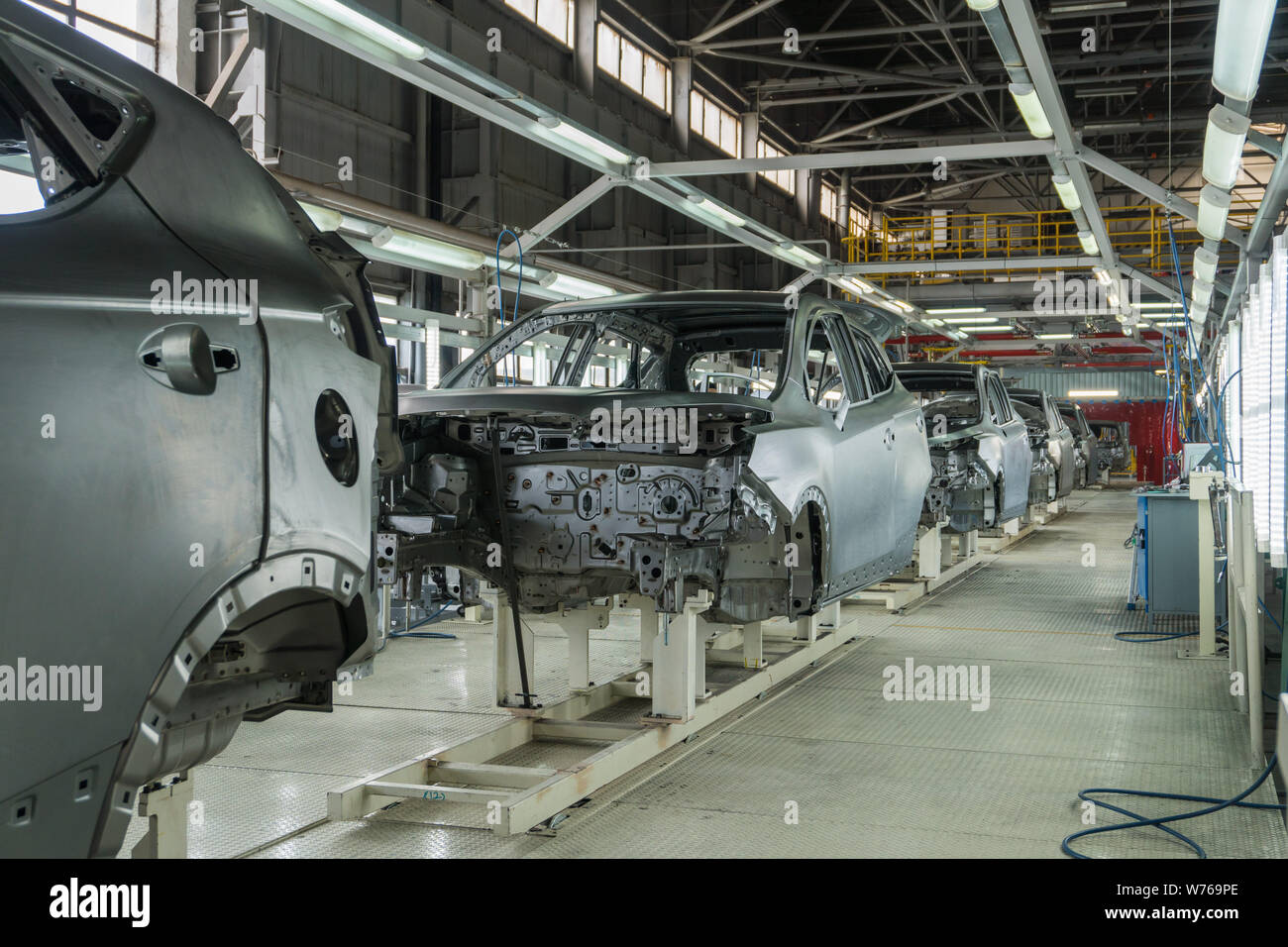 The conveyor consists of the bodies of cars. Assembling machines in the ...