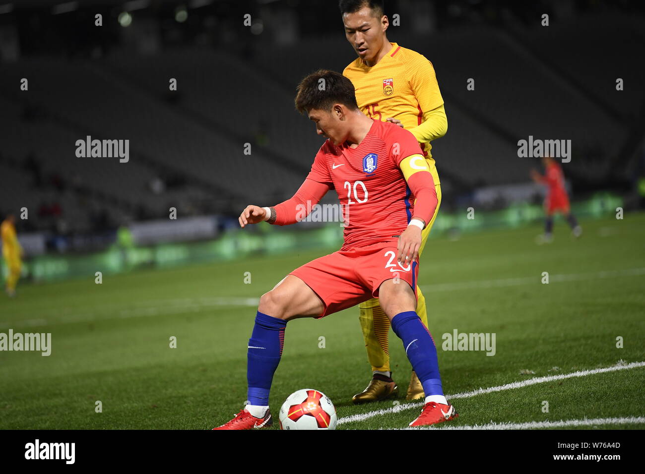 Jang Hyunsoo, front, of South Korea kicks the ball to make a pass ...