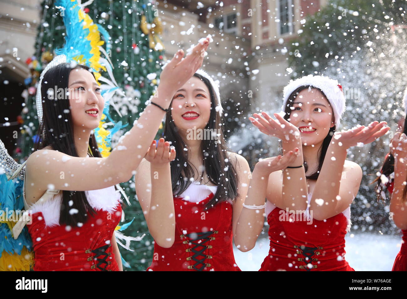 College students dressed in Santa Claus costumes take part in a ...