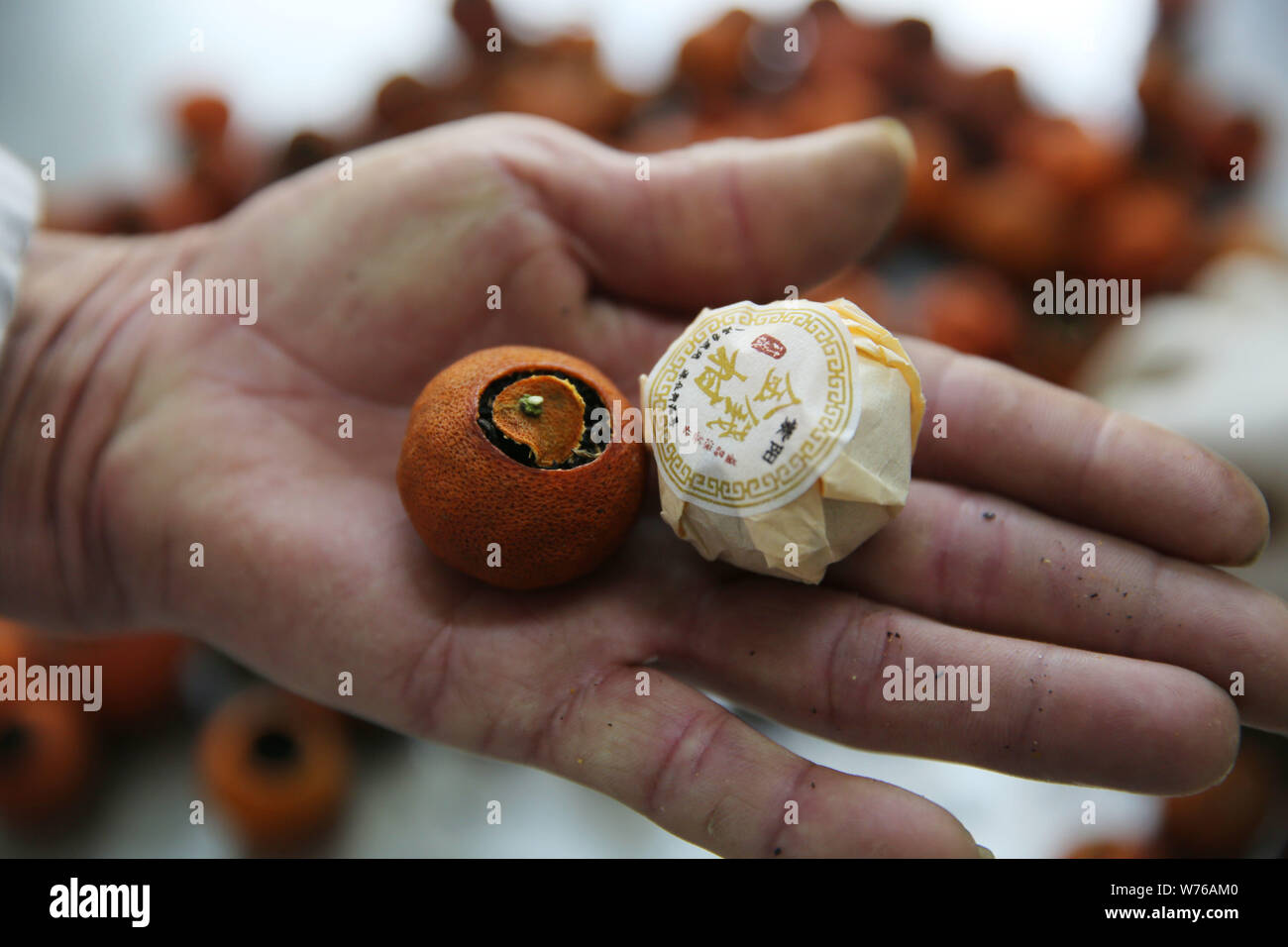 Chinese woman Tang Li shows the kumquat tea made by herself through ...