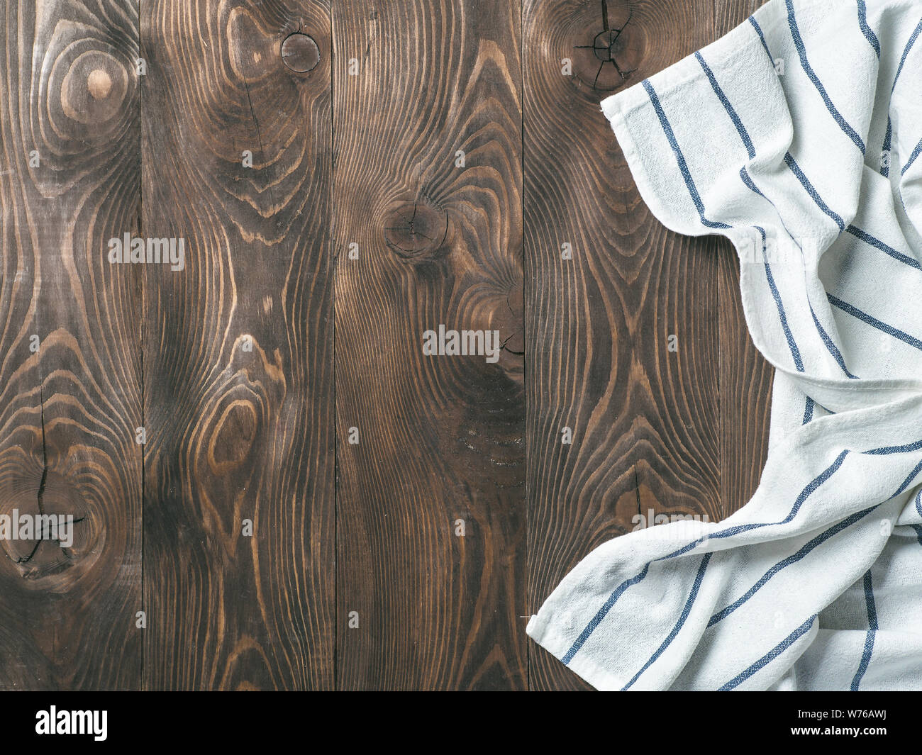 View from above on brown wooden table with linen kitchen towel or ...