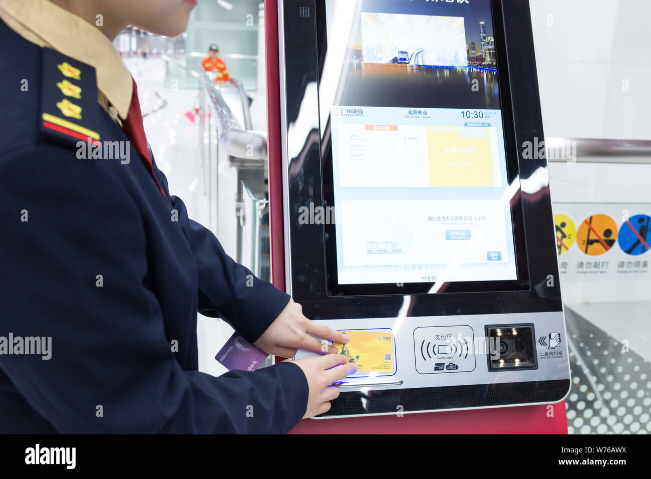 A Chinese staff shows how to use self-help customer service center in ...