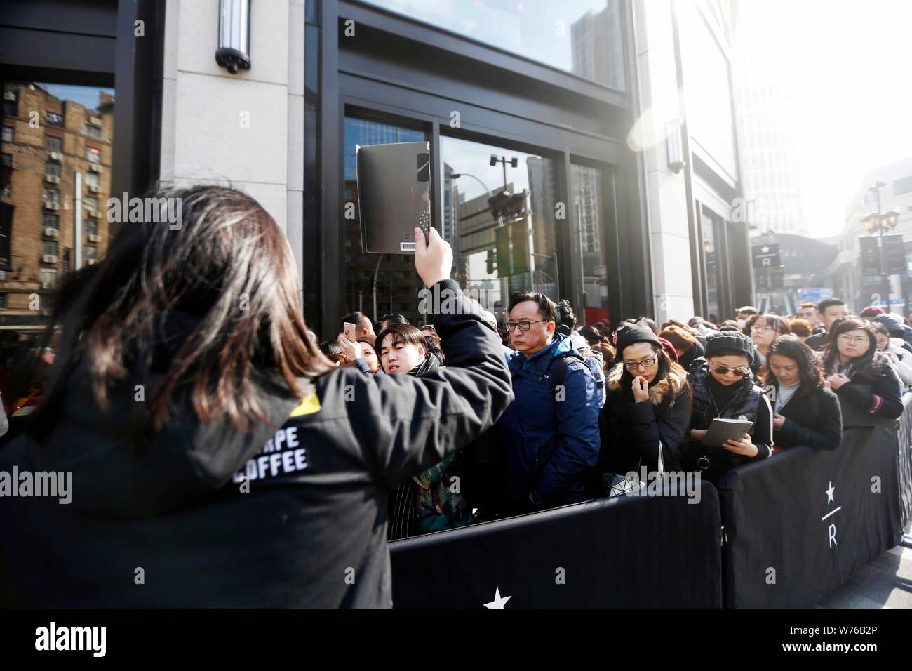 Customers queue up outside the world's largest Starbucks Reserve ...