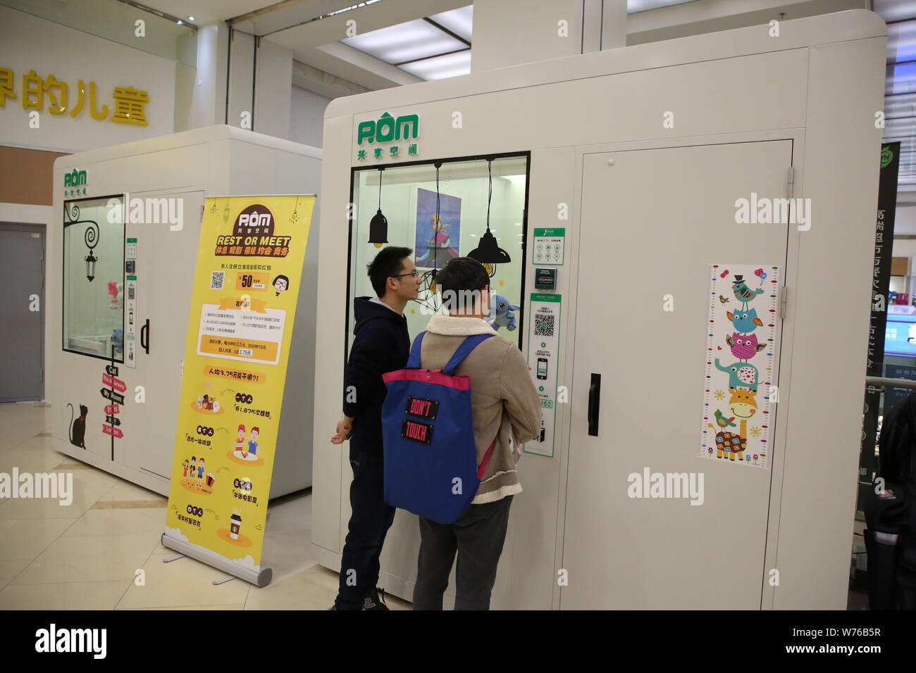 Customers look at a shared "lounge booth" called "Rest Or Meet" at a ...
