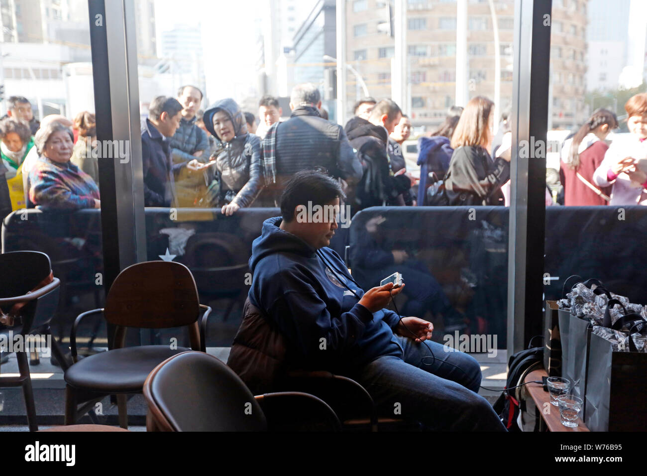 A customer enjoys his leisure time at the world's largest Starbucks ...