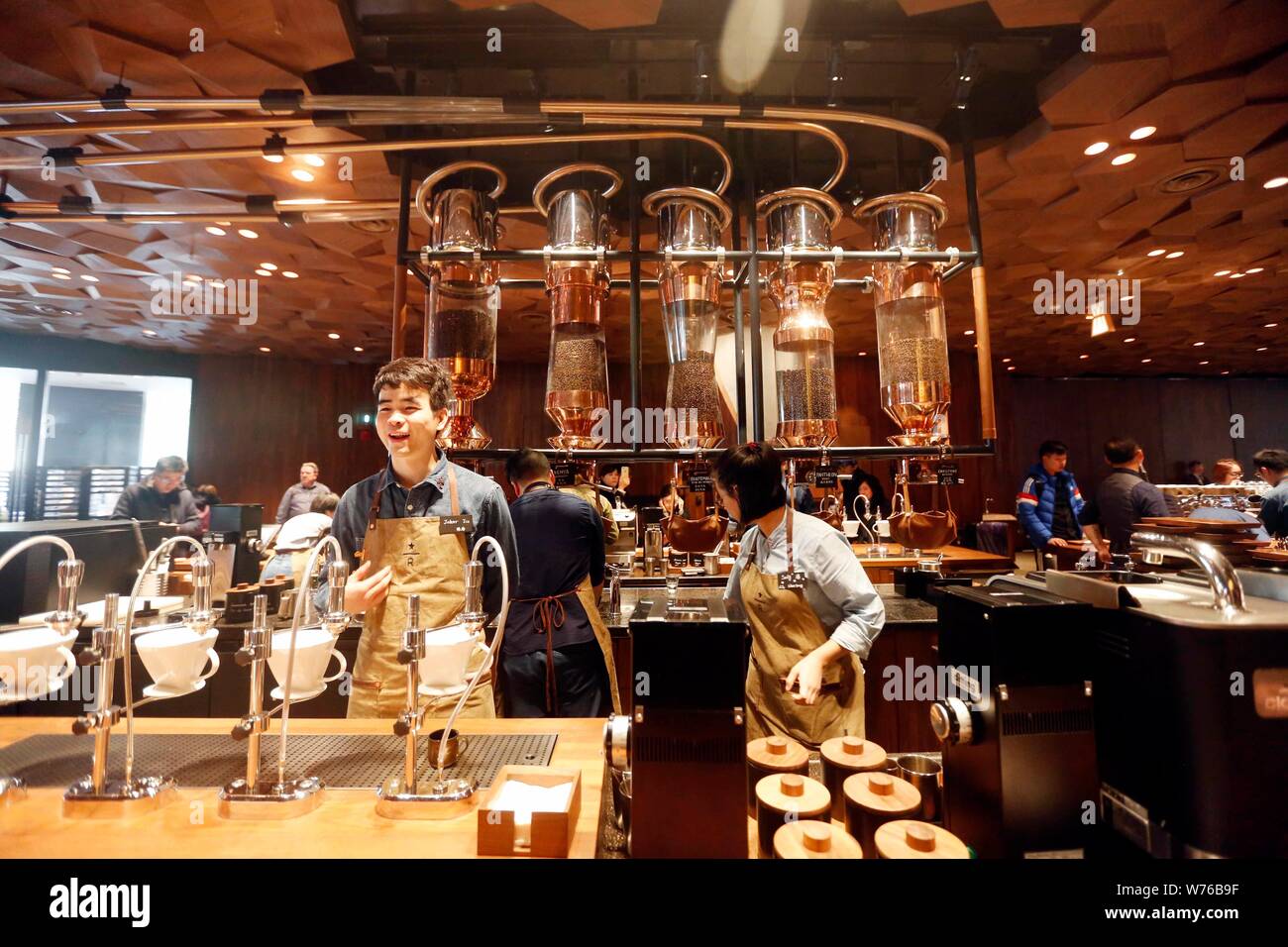 Baristas prepare coffee for customers at a coffee bar of the world's ...