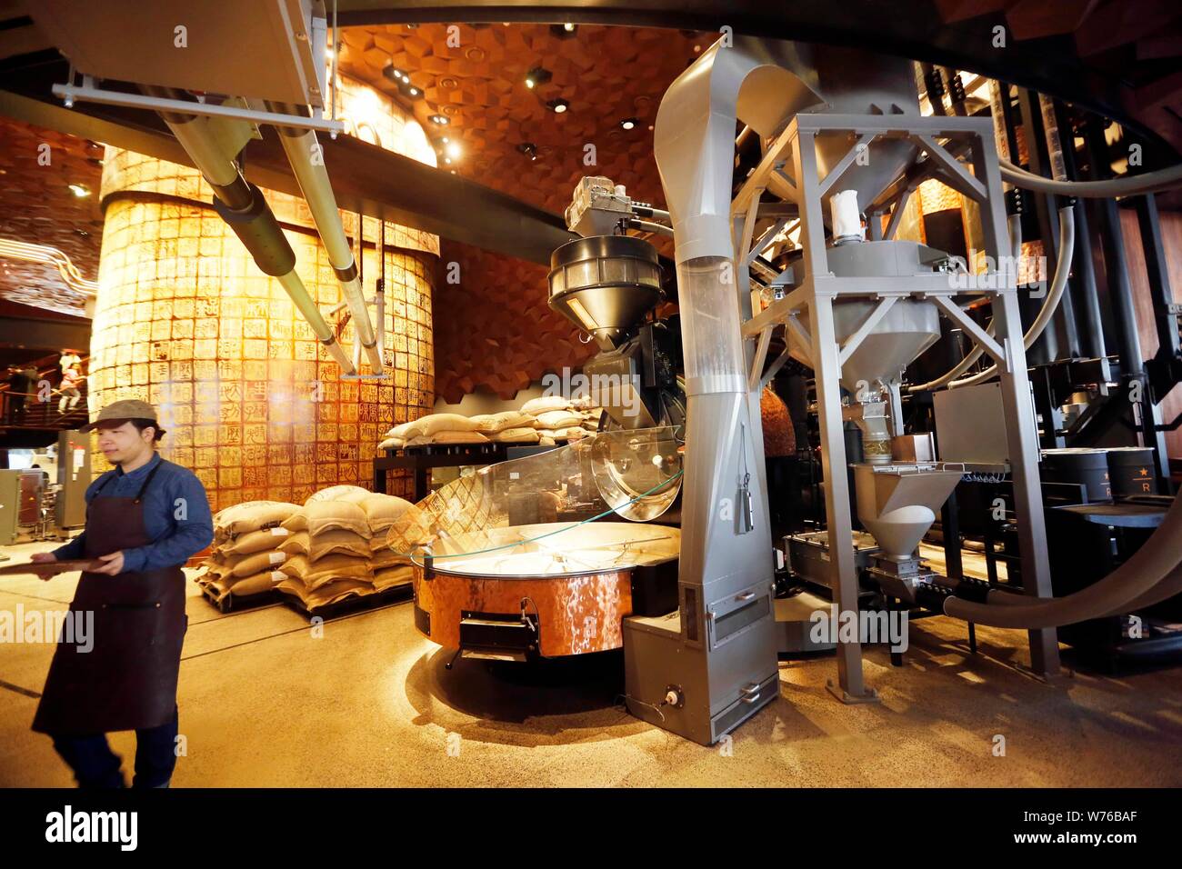 An employee works at a coffee bar of the world's largest Starbucks ...