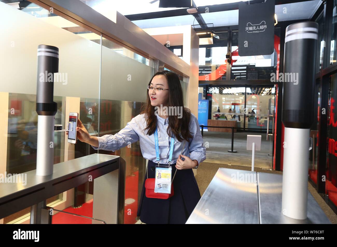 A visitor experiences "smiling to get discounts" at an Alibaba's Tmall ...