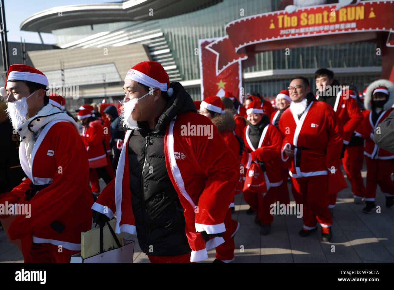 Participants dressed as "Santa Claus" take part in the Santa Run 2017 ...