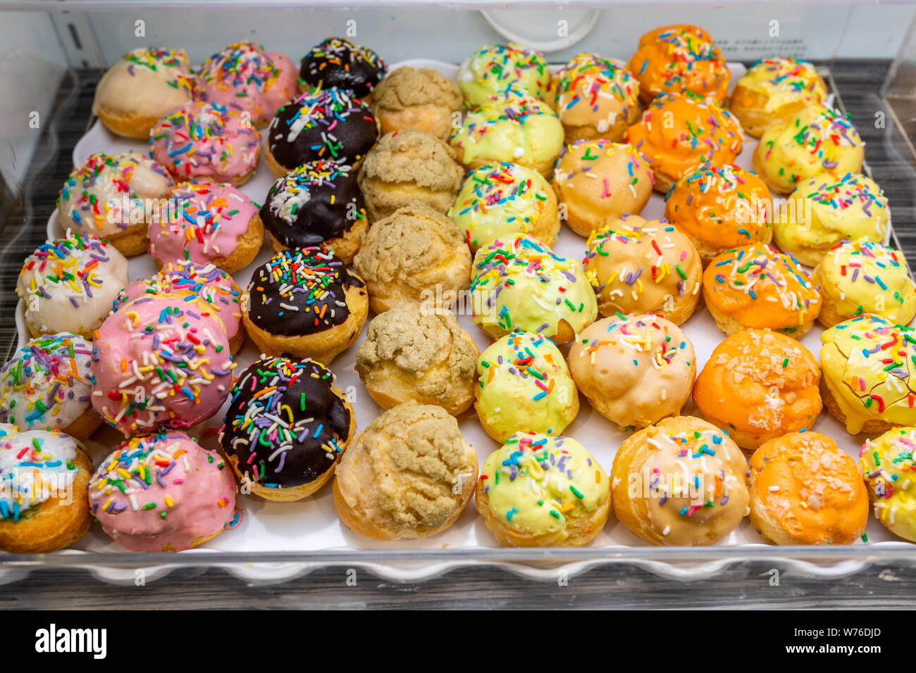 Puffy choux decorated with colorful icing sugar and candy sprinkles ...