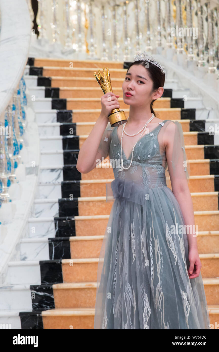 Winner Chinese girl Yue Han poses with her trophy during the 11th Asian ...