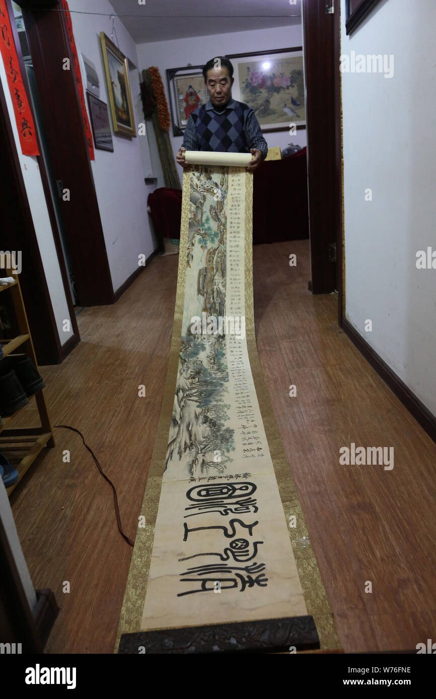 63-year-old retired Chinese teacher Yuan Xihe shows a six-meter-long ...