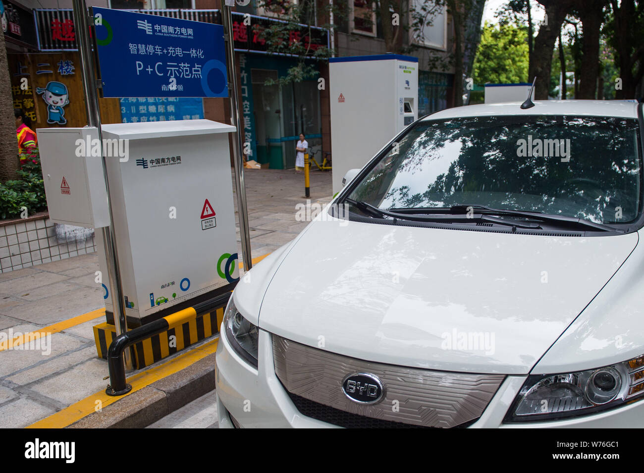 A BYD electric vehicle waits to be recharged at China's first roadside ...