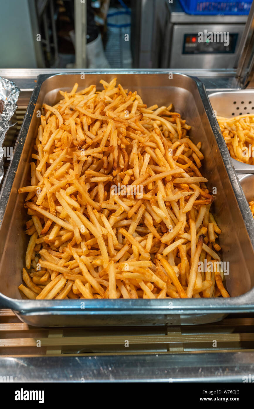 Tray of crispy french fries for sale at food stall Stock Photo - Alamy
