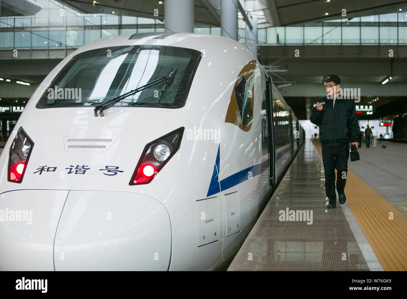 A Chinese staff checks a high speed bullet train on Xi'an¨CChengdu high ...