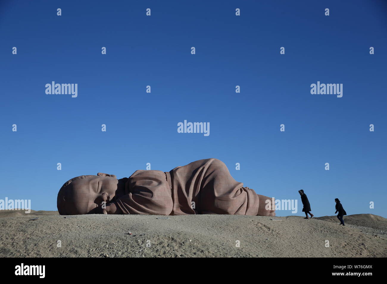 A giant 3D sleeping baby sculpture is on display on the Gobi Desert in ...