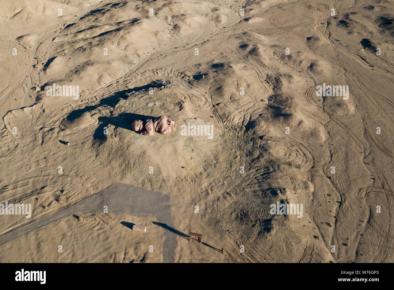 Aerial view of a giant 3D sleeping baby sculpture on display on the ...