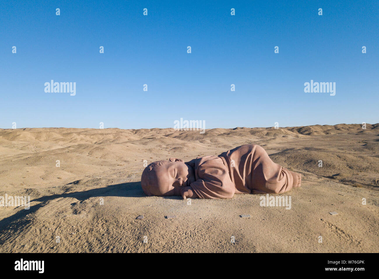 Aerial view of a giant 3D sleeping baby sculpture on display on the ...