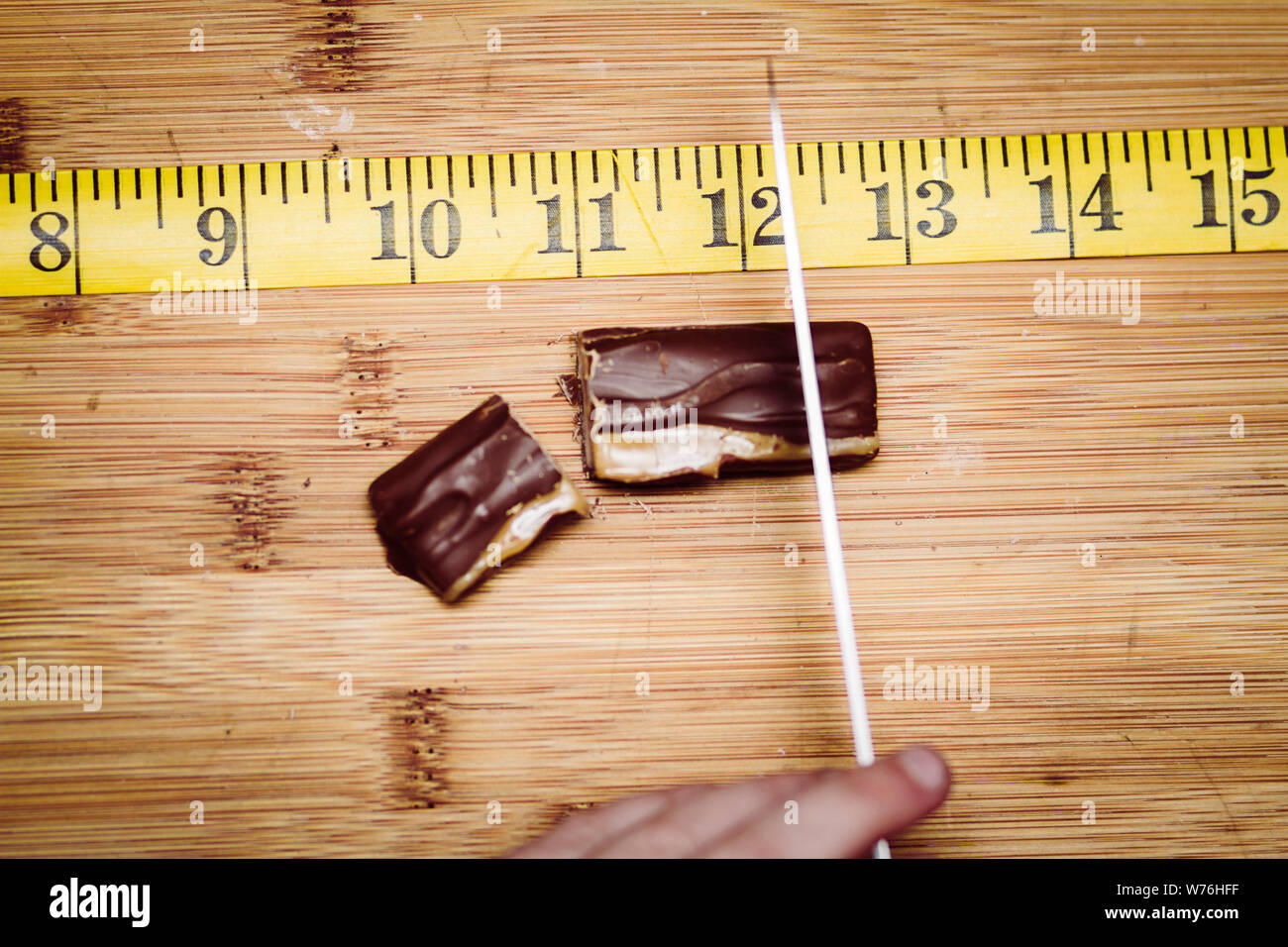 A chocolate bar being cut into exact equal portions Stock Photo - Alamy