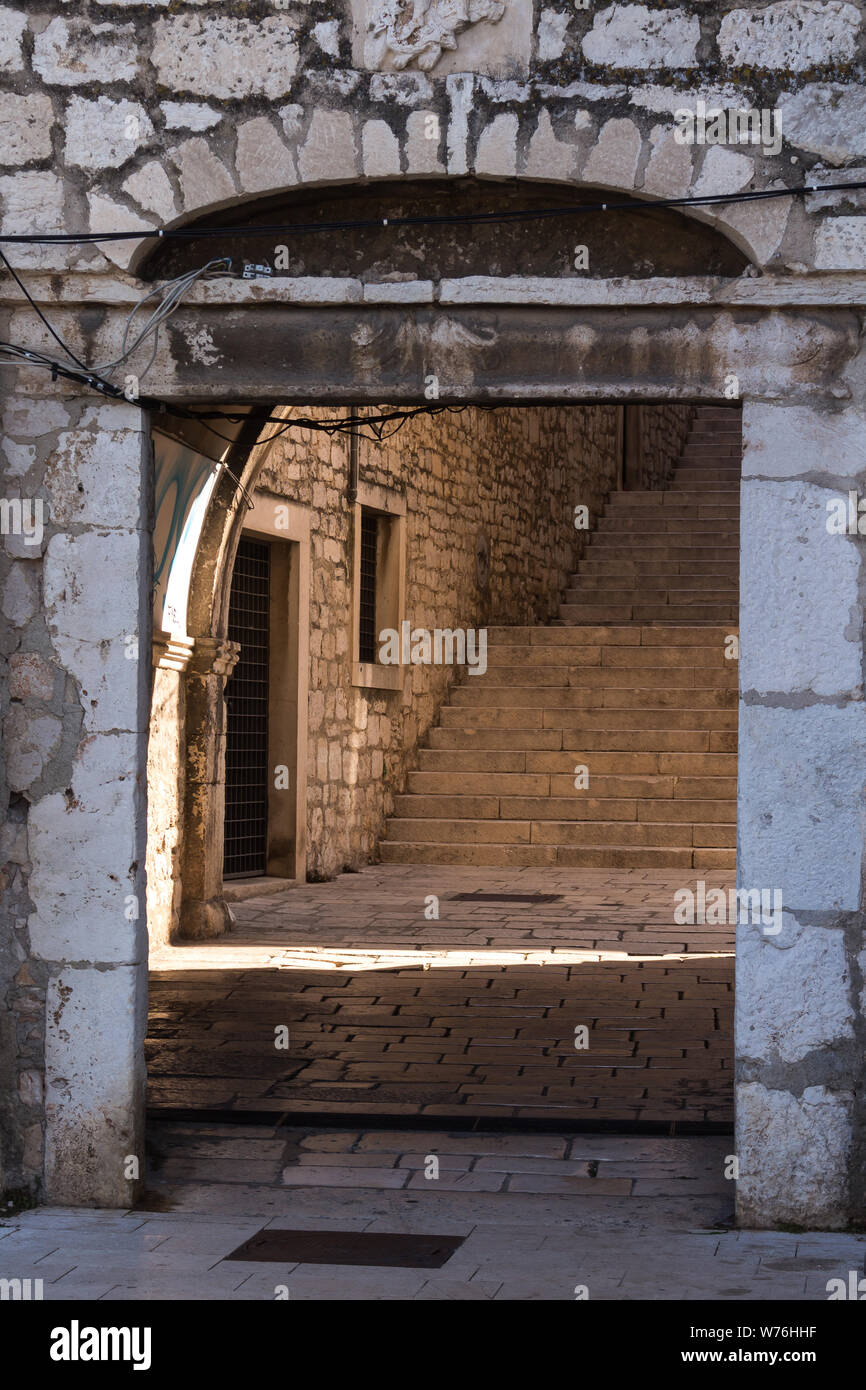 Wall made of stones. Gate to the old historic part of the city. Stairs ...