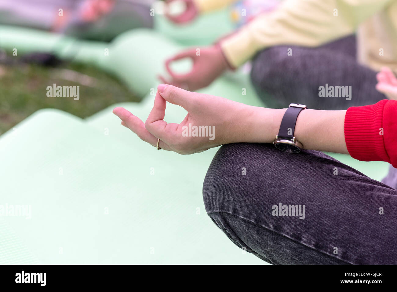 Groups of Women relaxation and meditation in city public Park in Summer ...
