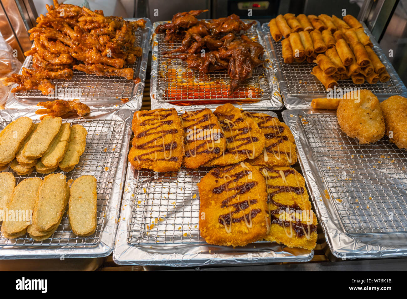 Tasty fried street food and spring rolls at night market Stock Photo ...