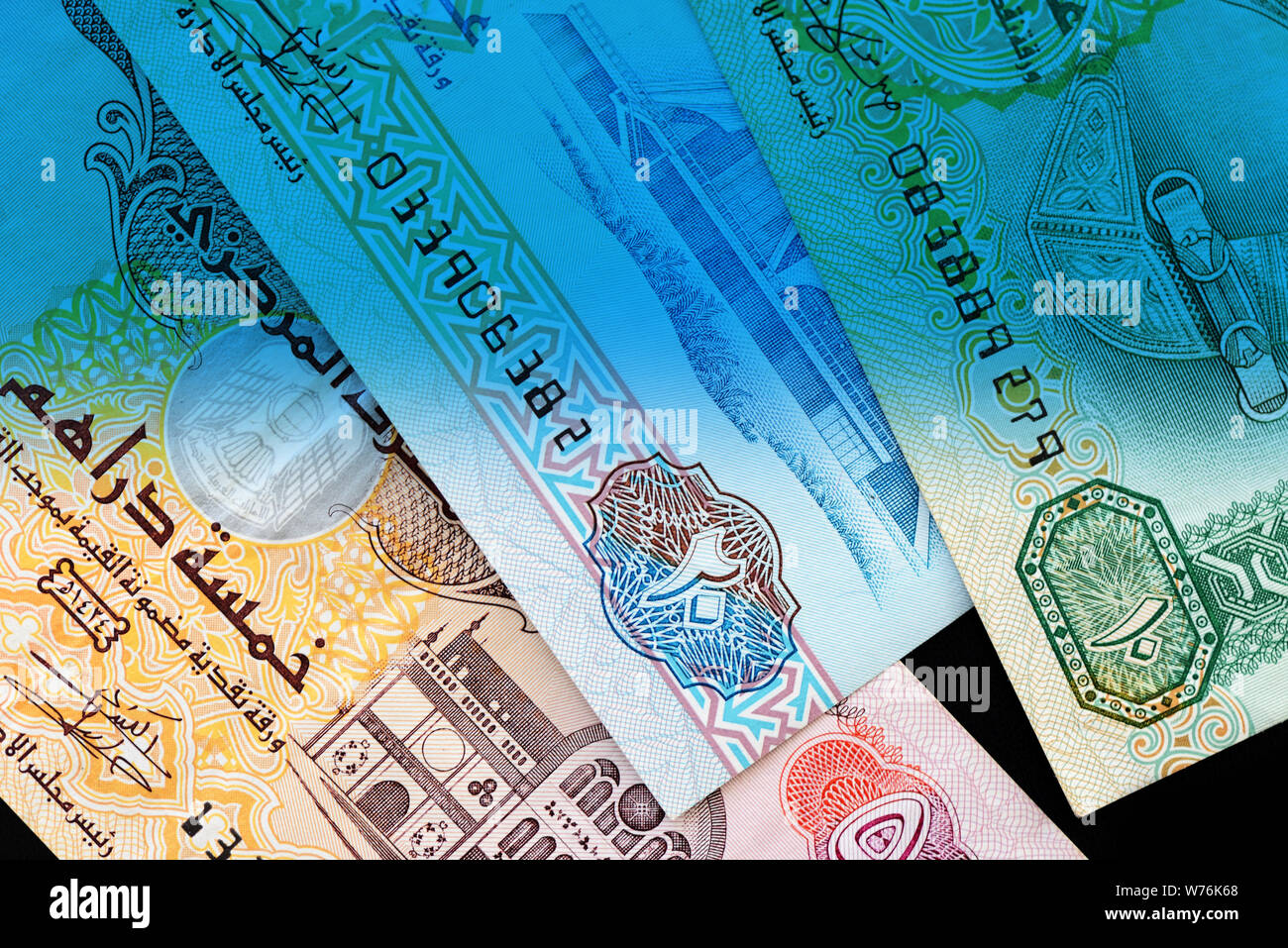 UAE dirham currency notes close up. Money background blue color toned ...